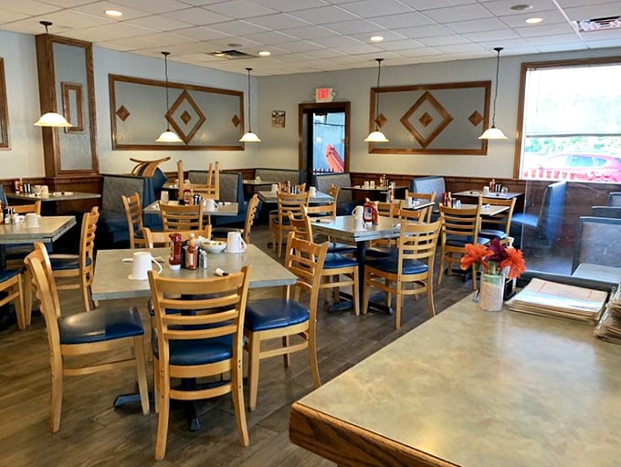 Light streams through the windows of this cozy dining room, where every table tells its own story of morning memories.