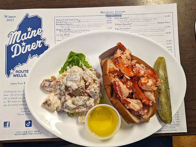 A proper Maine lobster roll served with potato salad &ndash; because sometimes happiness comes on a perfectly toasted bun.