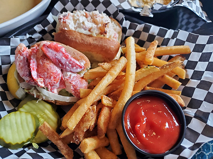 This is what happiness looks like: succulent lobster, golden fries, and a pickle that knows its supporting role.
