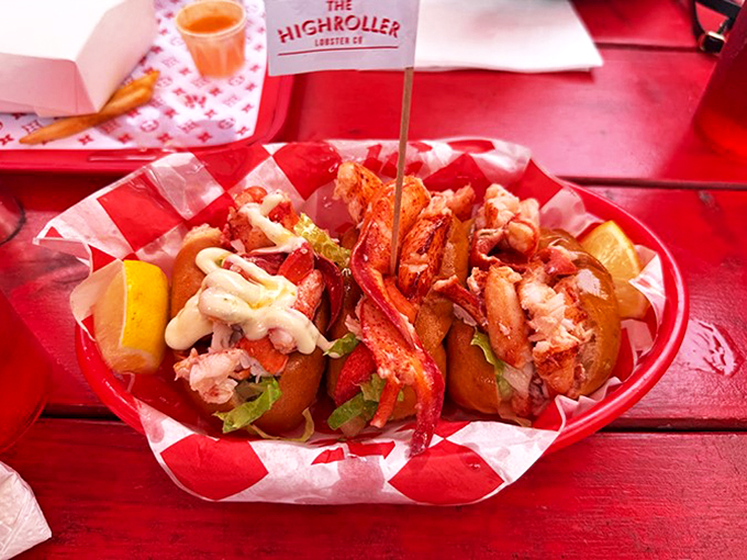 Three perfect lobster rolls stand at attention, each one saluting your taste buds with a different sauce symphony.