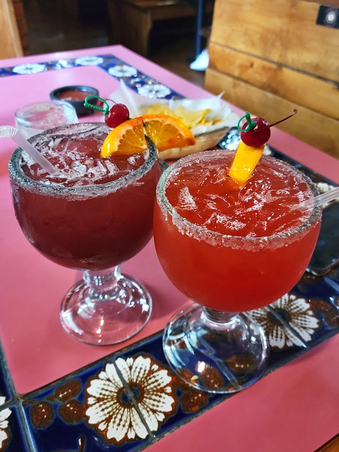 Double trouble never looked so good - these fruit-forward margaritas come dressed to impress with cherries and orange slices.