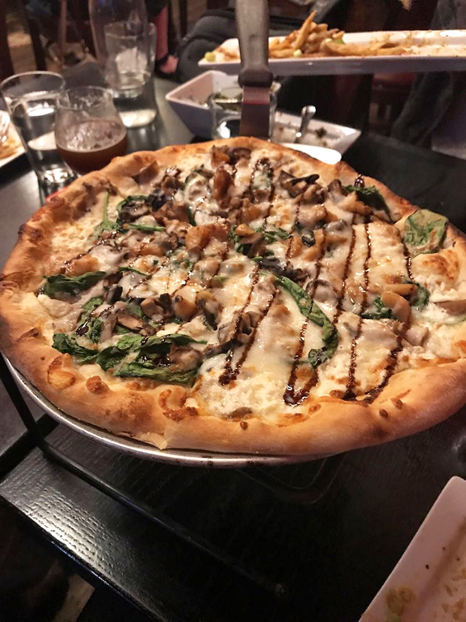 When mushrooms and melted cheese meet wood-fired crust, magic happens. The drizzle of balsamic adds that perfect finishing touch.