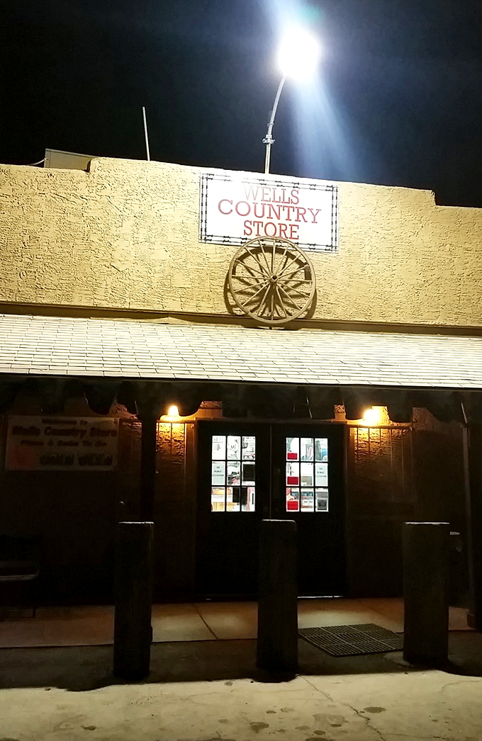 As night falls, Wells Country Store lights up like a beacon of deliciousness in the desert. It's dinner and a light show, folks!