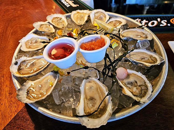 Fresh oysters on ice, arranged like pearls on a silver platter, with classic accompaniments standing by. 