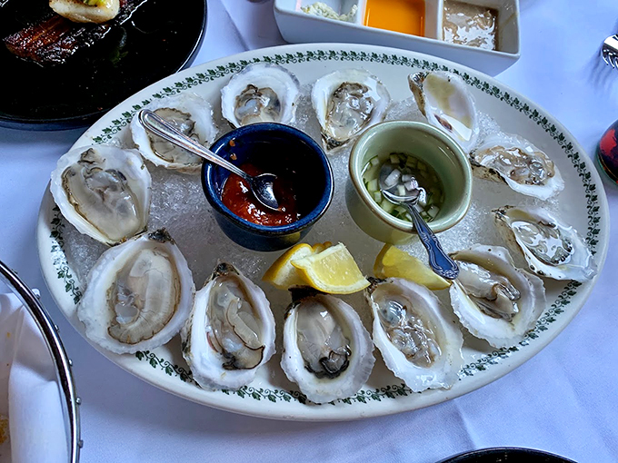 Fresh Maine oysters lounging on ice, waiting to brighten your day like pearls of the sea. Pure briny perfection!