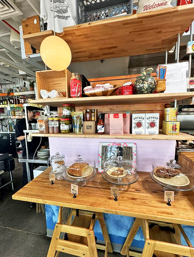 Fresh-baked treats under glass domes tempt passersby like a scene from a food lover's fairy tale.