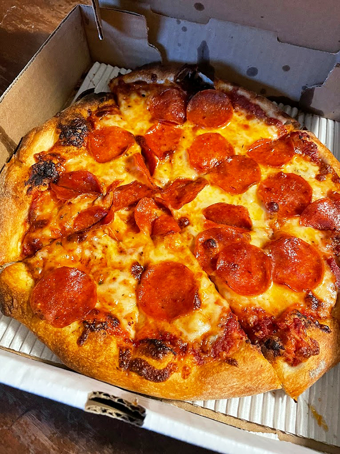 A pepperoni pizza that's achieved the perfect balance of crispy crust, melted cheese, and perfectly curled pepperoni cups.