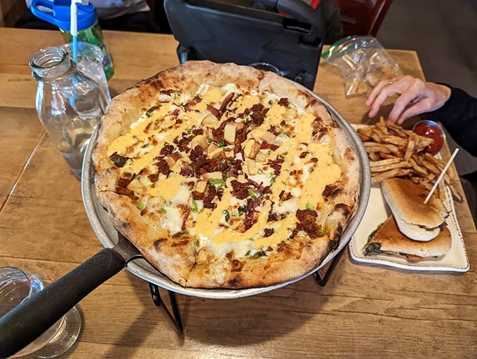 A wood-fired pizza masterpiece drizzled with sauce, proving that Bar Harbor knows more than just seafood.