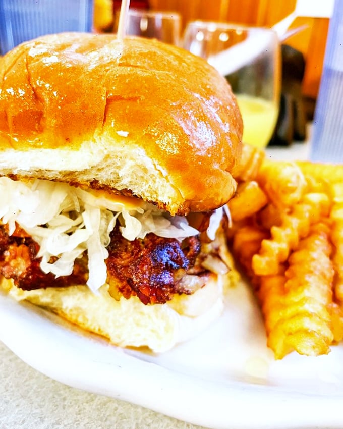 This isn't just a burger - it's comfort food engineering at its finest, with those crispy fries standing guard.