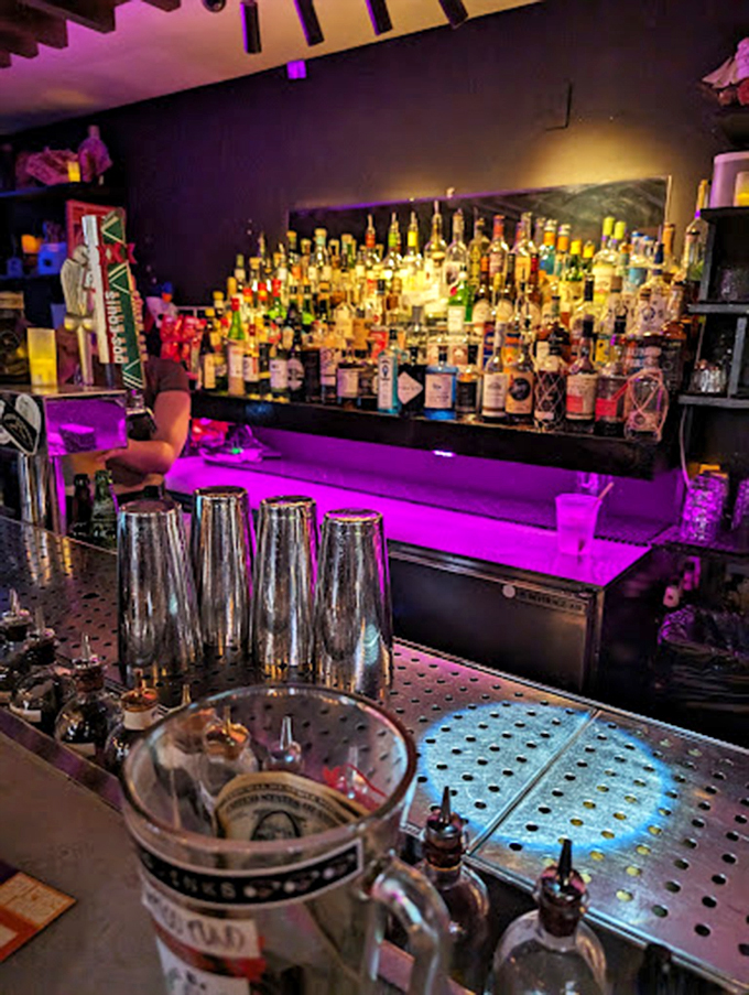 Like a scene from a modern western, this backlit bar glows with promise and premium spirits under purple mood lighting.
