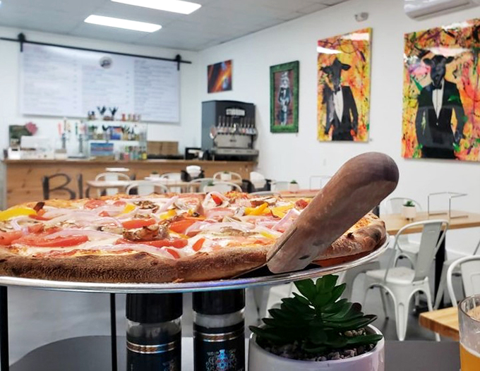 Fresh ingredients dance across perfectly charred crust, proving that vegetarian options can be just as indulgent as their meaty counterparts.