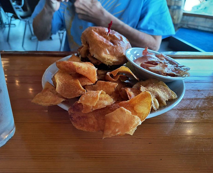 A burger that commands attention, topped with house chips that add a satisfying crunch to every bite.