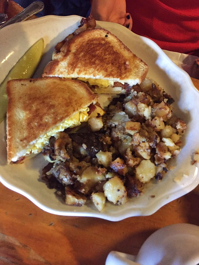 The breakfast sandwich of champions! Golden toast, melty cheese, and those legendary home fries – it's a plate that screams "good morning, delicious!"