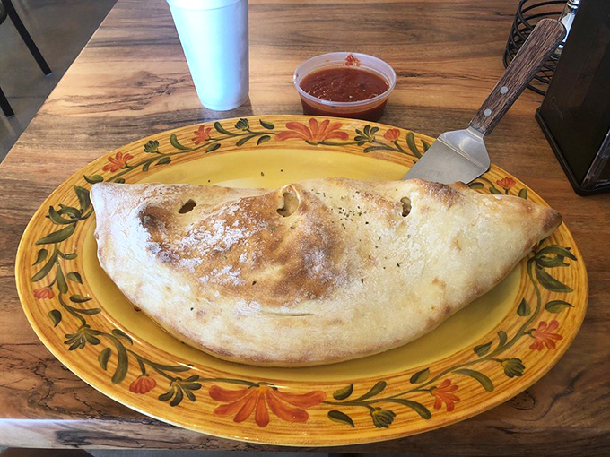 Meet the calzone that thinks it's a golden croissant. Flaky on the outside, pure Italian bliss on the inside.