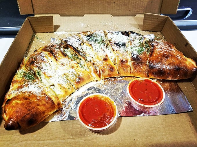 Behold, the calzone of your dreams! This golden-brown beauty is what happens when pizza decides to get all fancy and fold itself in half.