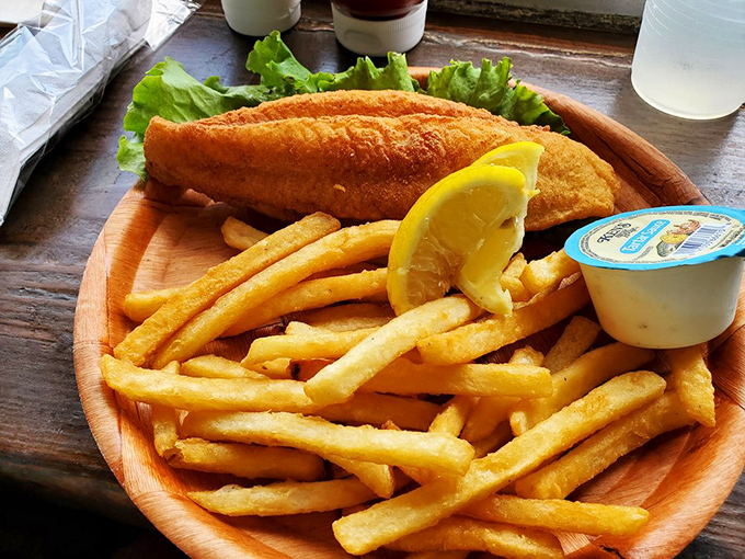 You can't beat this classic: crispy fried catfish and a mountain of golden fries!