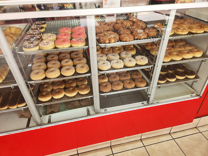 A display of happiness featuring chocolate, pink frosted, and cinnamon-sugar classics - each one a different path to joy.