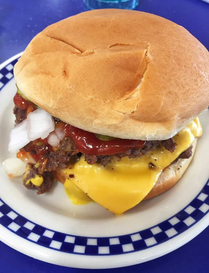 Holy moly, that's a burger! This double-decker delight is stacked higher than my to-read pile. It's not just a meal, it's an edible skyscraper.
