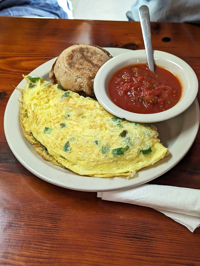 Behold, the omelet of your dreams! Packed with veggies and oozing cheese, it's like a garden party wrapped in an eggy sleeping bag.