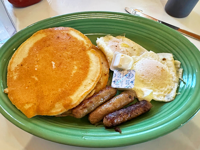 Pancakes so fluffy, they could double as pillows. Topped with eggs and sausage, it's a breakfast ménage à trois that'll make your taste buds swoon.