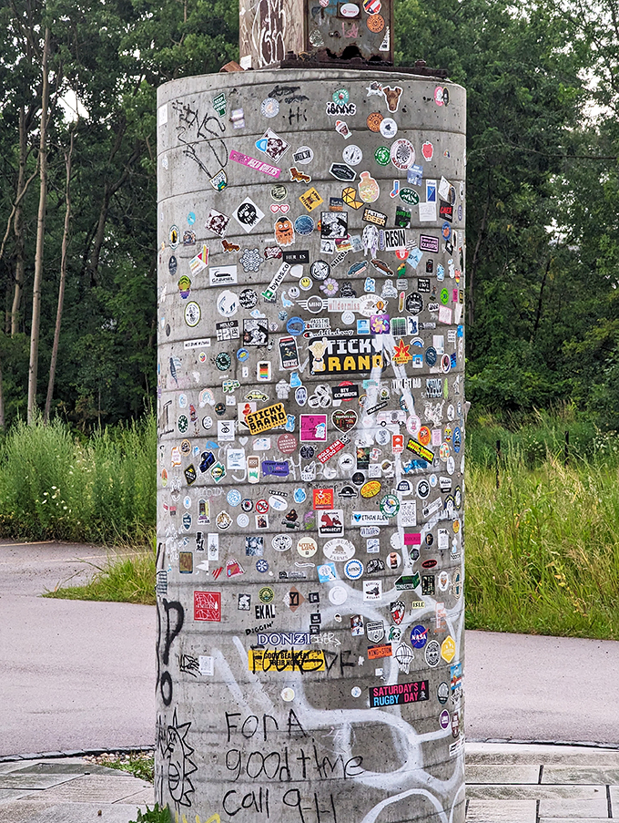 The base is a concrete canvas of colorful stickers. It's like someone decided to turn "I Spy" into an extreme sport.