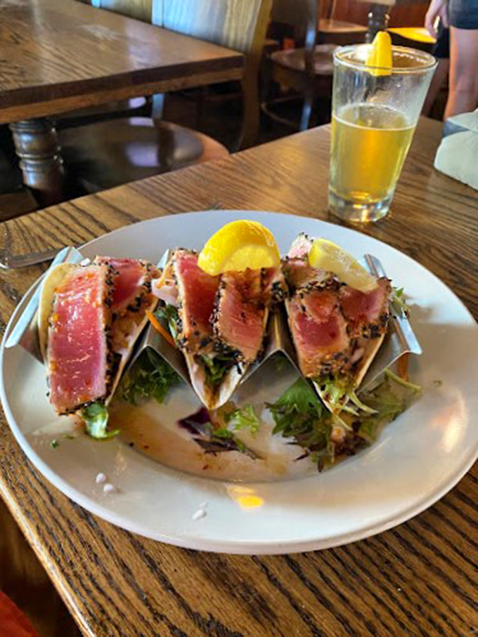 These seared tuna tacos are dressed to impress, showing off their rare centers like nature's jewelry on a bed of fresh greens.