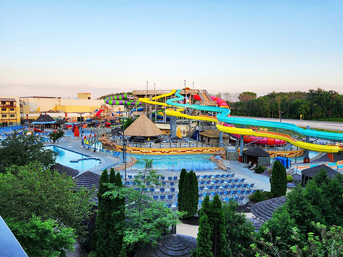 Towering water slides emerge like colorful tentacles reaching for the summer sky.