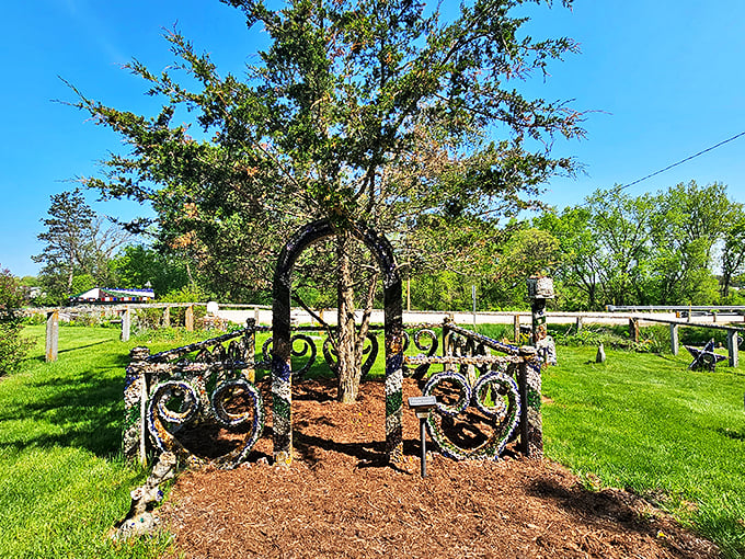 A whimsical archway adorned with found objects and sparkling embellishments stands as a gateway to one artist's imaginative universe.