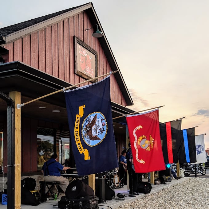 Military flags flying high, BBQ smoking low and slow. It's patriotism you can taste &ndash; God bless America, and pass the ribs! Photo credit: Wendy Solum