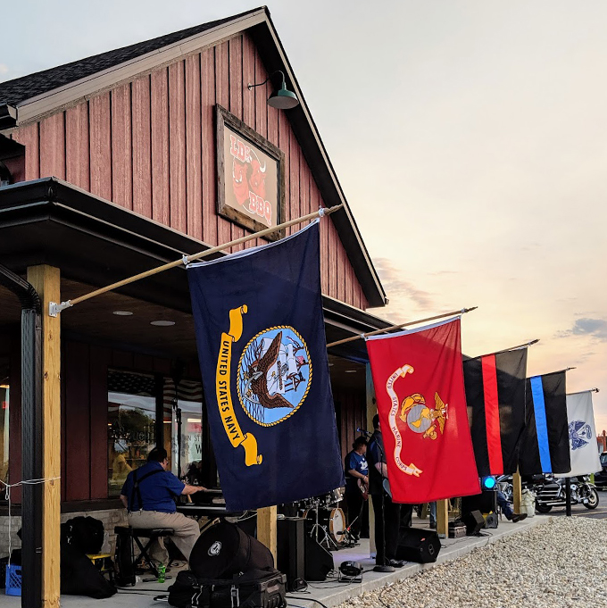 Military flags flying high, BBQ smoking low and slow. It's patriotism you can taste &ndash; God bless America, and pass the ribs! Photo credit: Wendy Solum