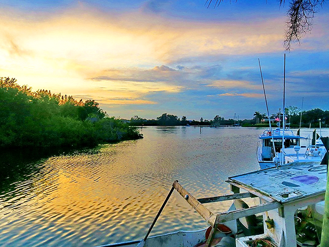 Nature's golden hour paints the water like liquid amber, while fishing boats rest quietly at dock. A Florida sunset worth bottling up and taking home.
