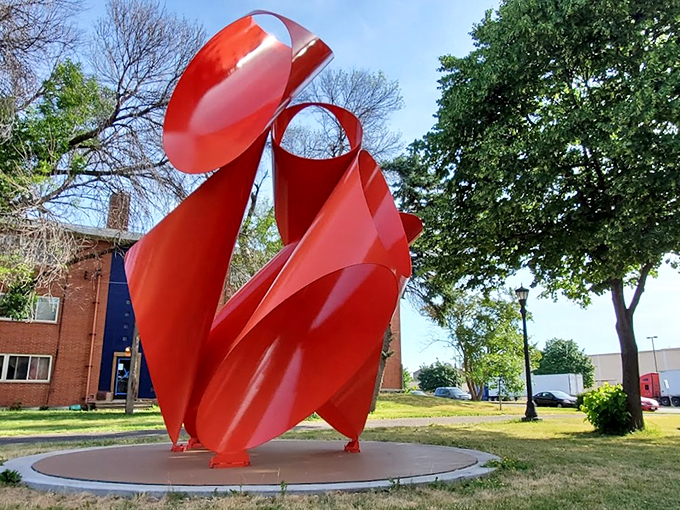 Twists, turns, and a whole lot of red! This sculpture looks like it's trying to tie itself in knots. Talk about flexible art!