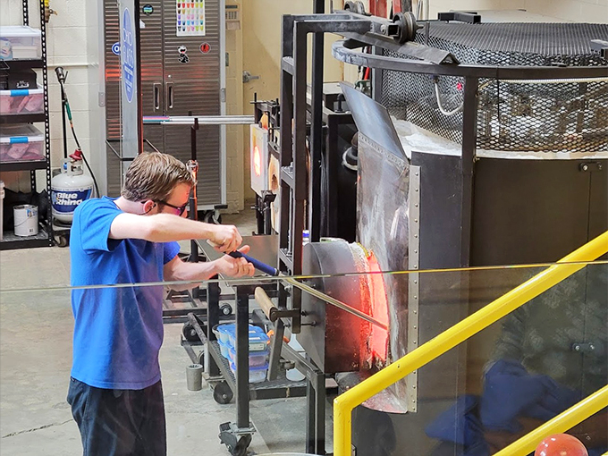 Watch the glass whisperer at work! This artisan dances with fire and sand, creating beauty that's anything but fragile.