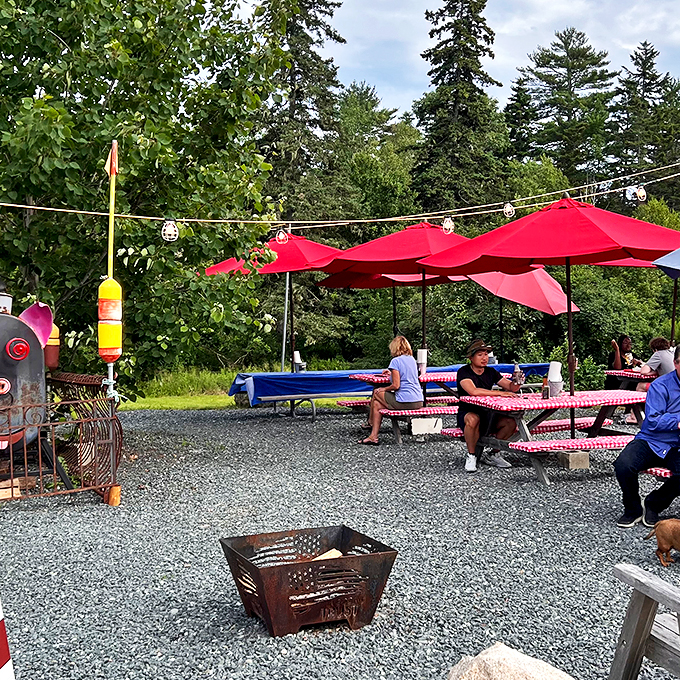 Picnic tables under red umbrellas: where lobster dreams and summer memories are made. Pass the butter, please!