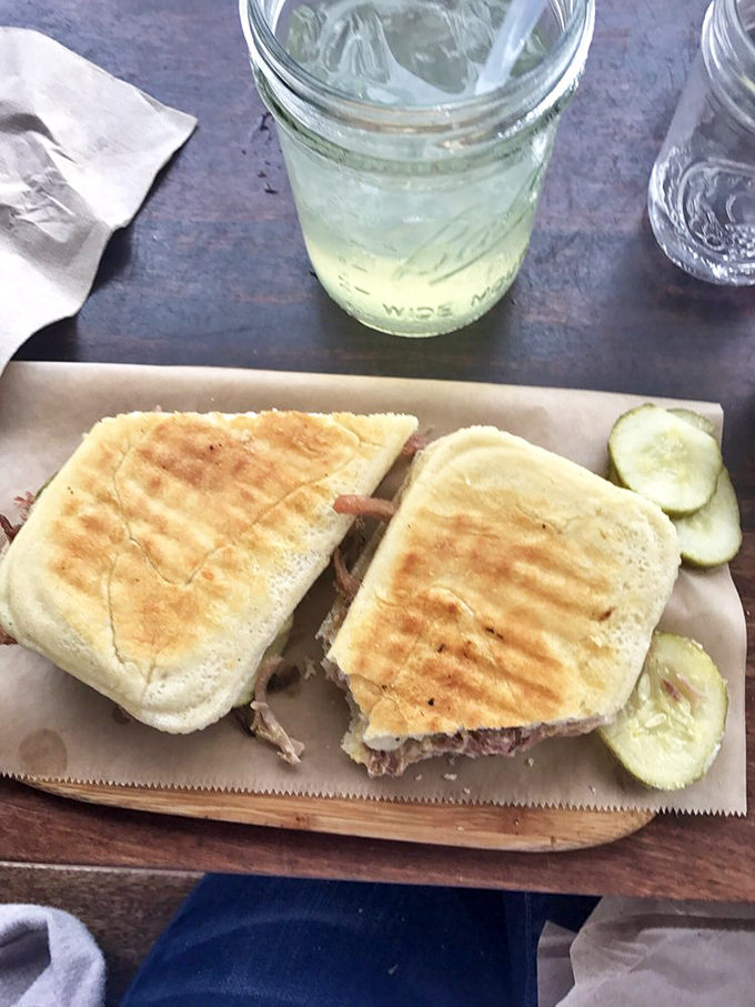 Pulled pork perfection between two slices of heaven. This sandwich doesn't just hit the spot &ndash; it does a happy dance on it.