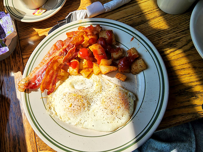 The holy trinity of breakfast, perfectly executed. This plate is like a warm 'good morning' from Vermont itself, with a side of crispy, bacony love.