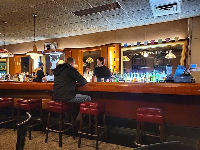 Where strangers become regulars and regulars become family, this polished wood bar has heard more stories than a library.