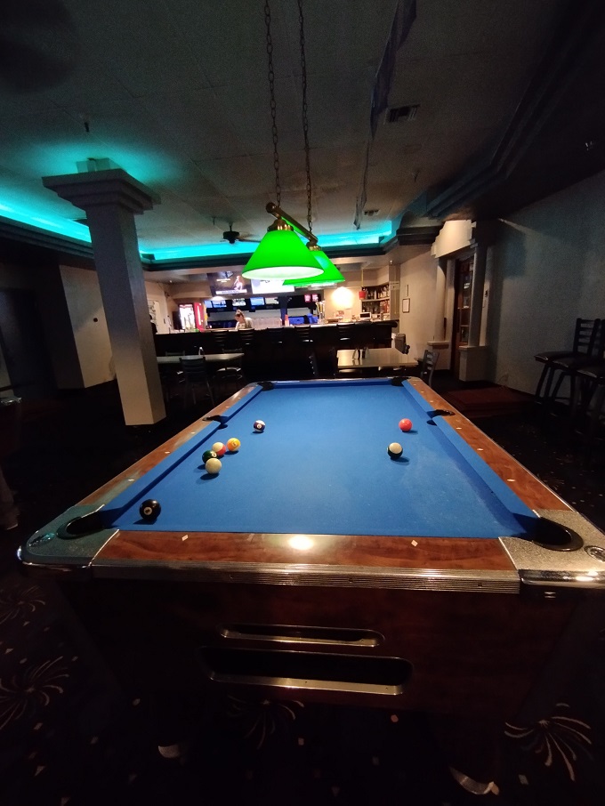 When bowling takes a break, the billiards area offers another classic game under warm lighting and retro charm.