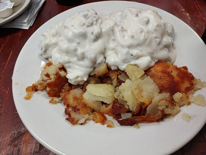A symphony of textures on a plate. Crispy home fries provide the perfect counterpoint to the creamy embrace of biscuits and gravy.