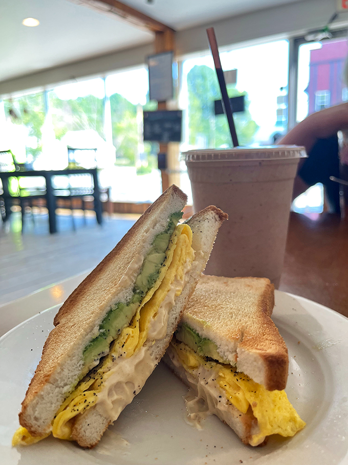 The dynamic duo of breakfast champions: a hearty sandwich and a creamy smoothie. It's like Batman and Robin, but way more delicious.
