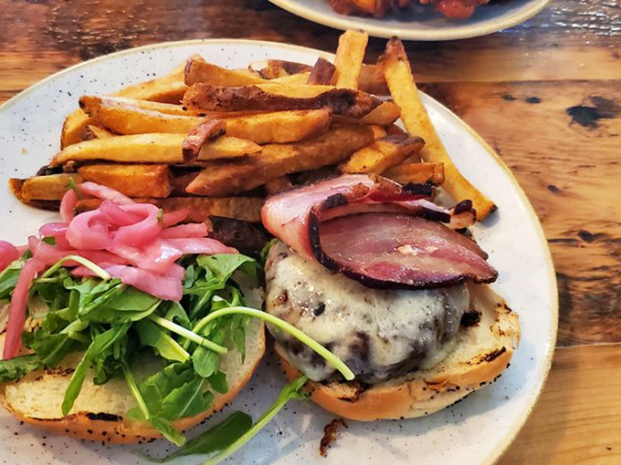 This burger, crowned with perfectly melted cheese and fresh greens, is what food dreams are made of.