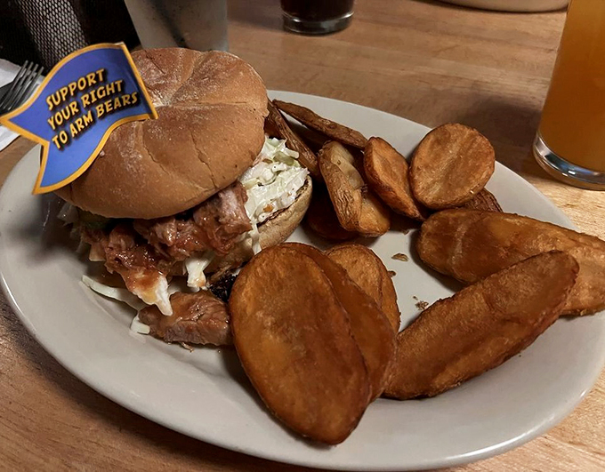 "Support Your Right to Arm Bears" reads the playful flag atop this hefty burger, surrounded by house-made potato chips.