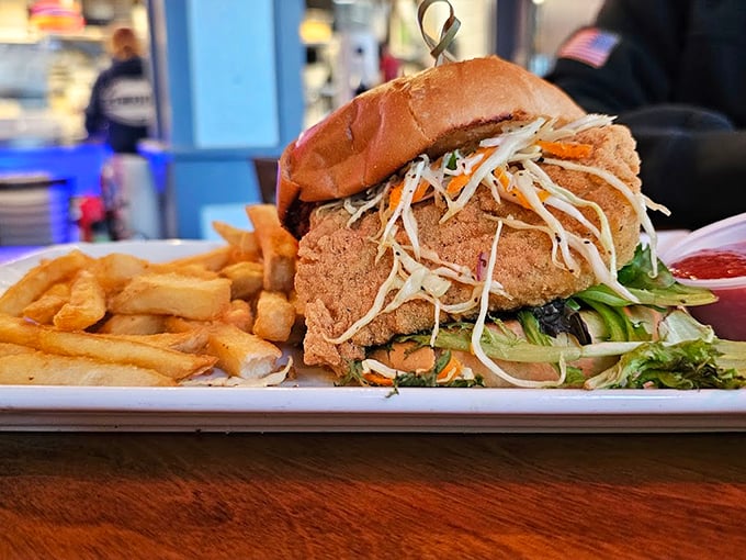 This towering creation isn't just a sandwich &ndash; it's a masterpiece of crispy coating and fresh slaw that demands your full attention. Photo credit: Joseph hpesoJ
