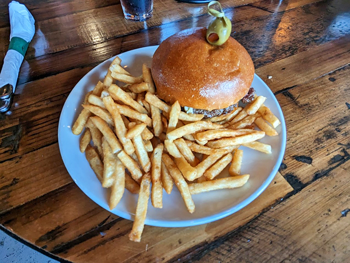 Golden fries surround this burger like a crispy crown, proving simple pleasures make the best lakeside companions.