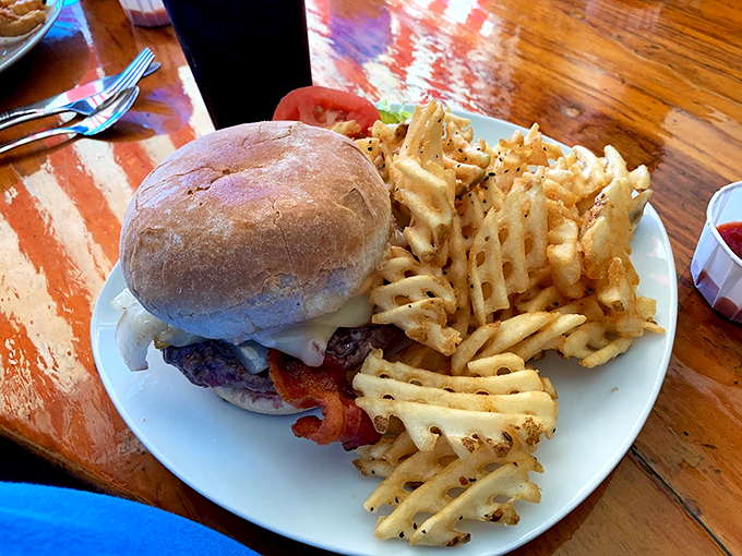 A burger that means business, accompanied by waffle fries so perfectly crisp they deserve their own fan club.
