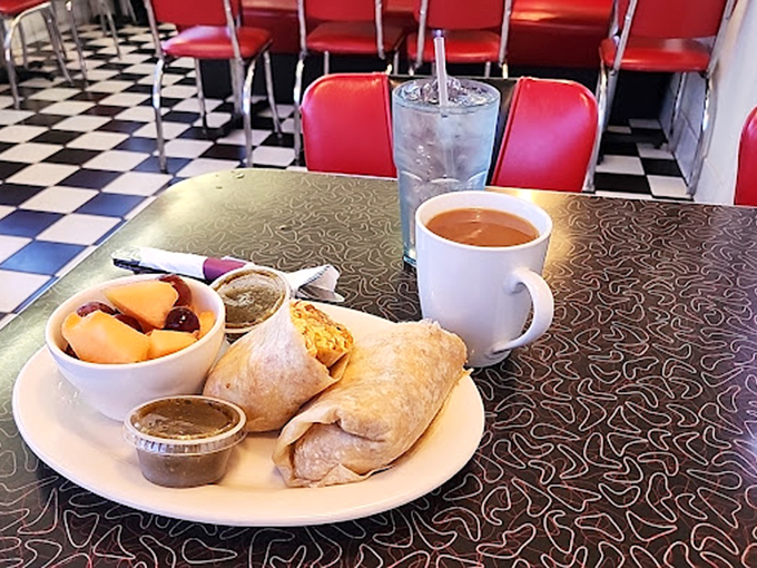 The breakfast burrito arrives like a morning symphony - perfectly wrapped, generously stuffed, with fresh fruit on the side.