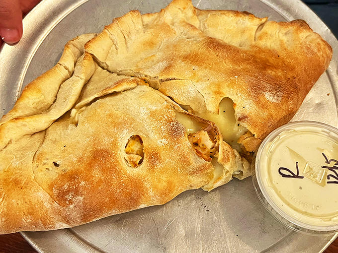 Cheese lovers, rejoice! This calzone is so packed with gooey goodness, it could probably power a small city.