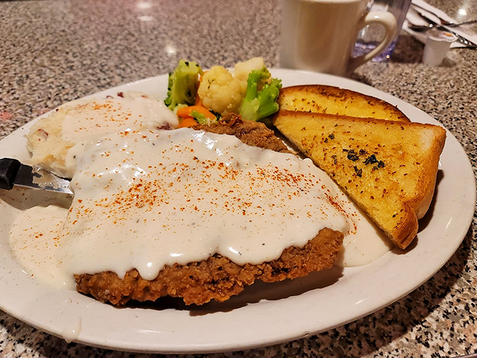 Country-fried steak swimming in creamy gravy, because some comfort foods are worth every single calorie. Photo credit: Kiara R