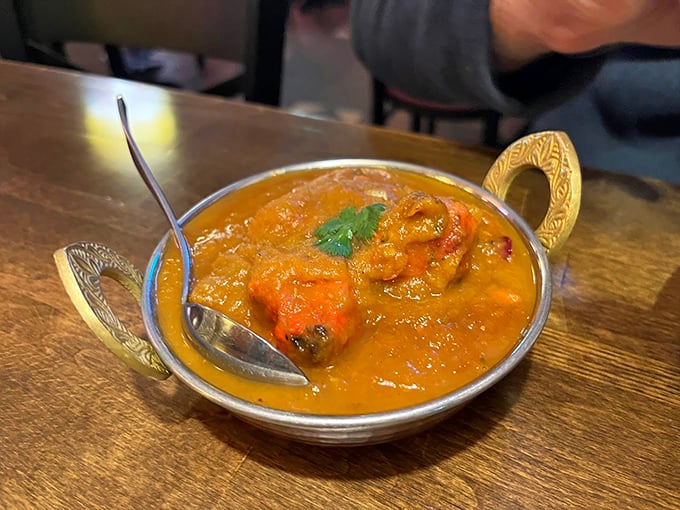 The chicken tikka masala arrives in its golden glory, ready to prove that some of life's best comfort food comes in copper bowls. Photo credit: Rose Xi