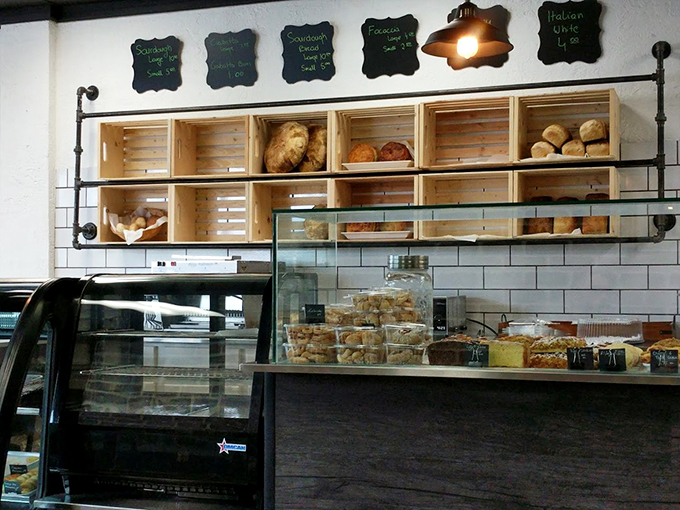 Wooden crates filled with fresh-baked treasures line the wall like a rustic gallery of grain-based masterpieces.